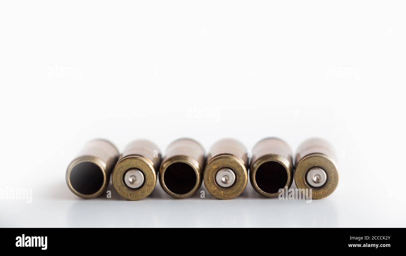Used 9 mm bullet casings in a row Stock Photo - Alamy