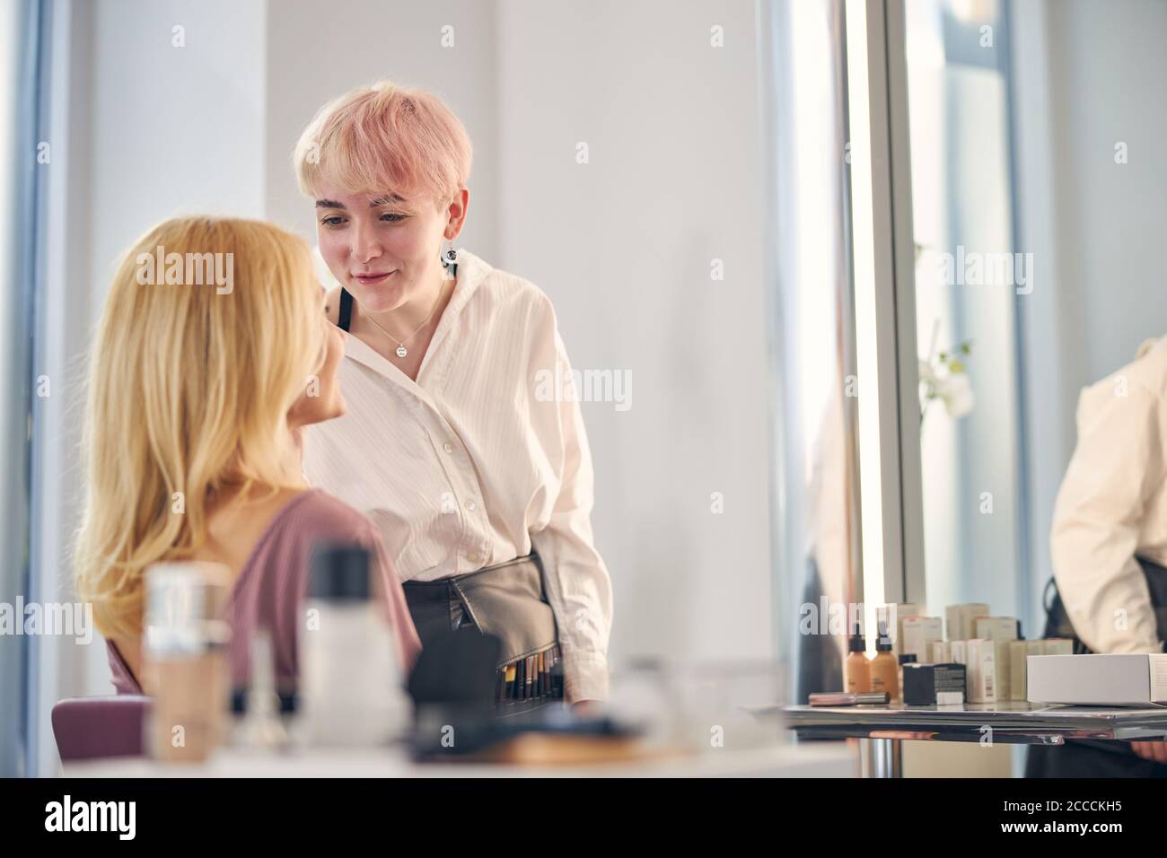 Positive delighted stylish woman working in beauty salon Stock Photo ...