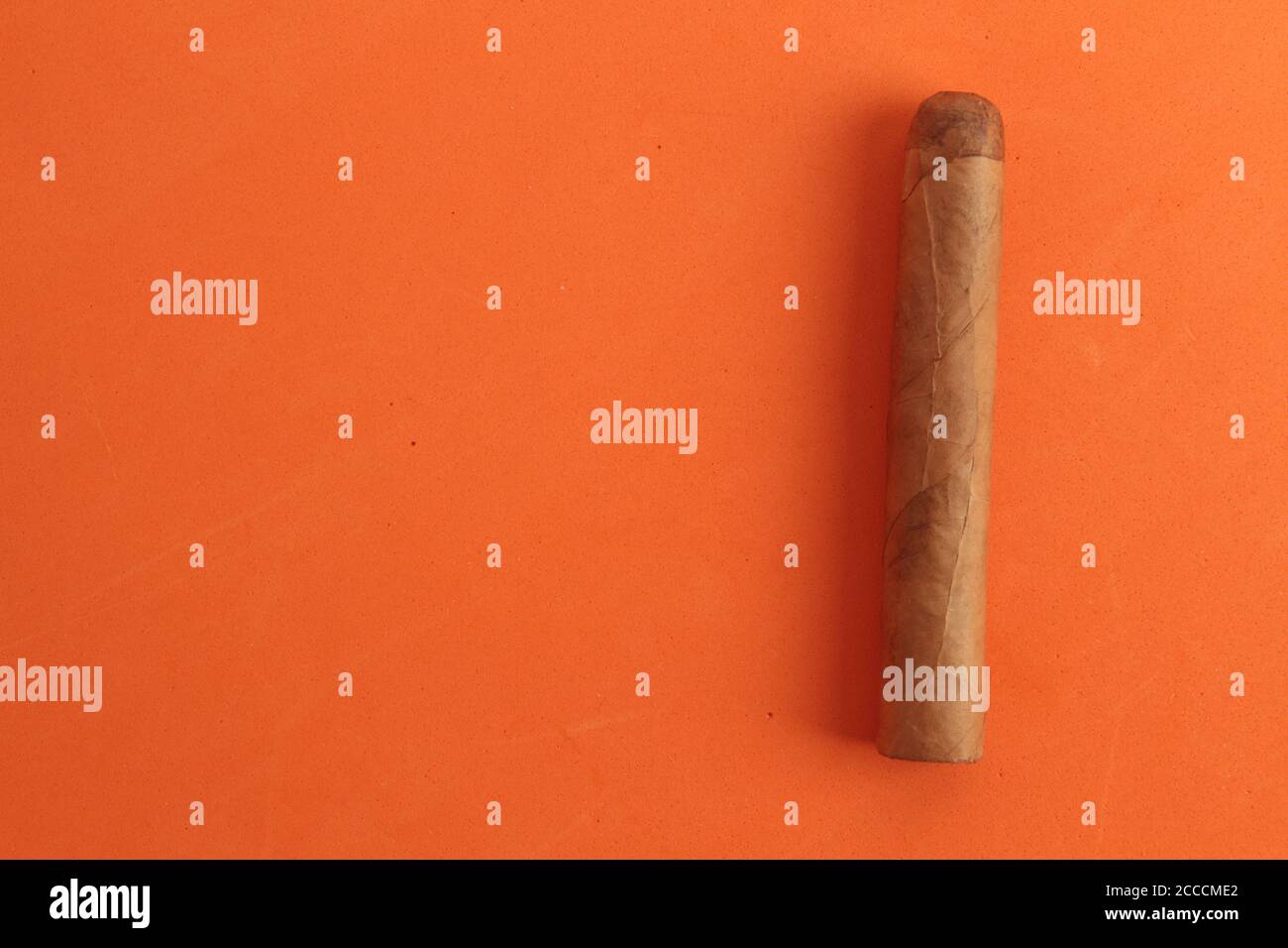 Top view of a tobacco cigarette on an orange background Stock Photo - Alamy