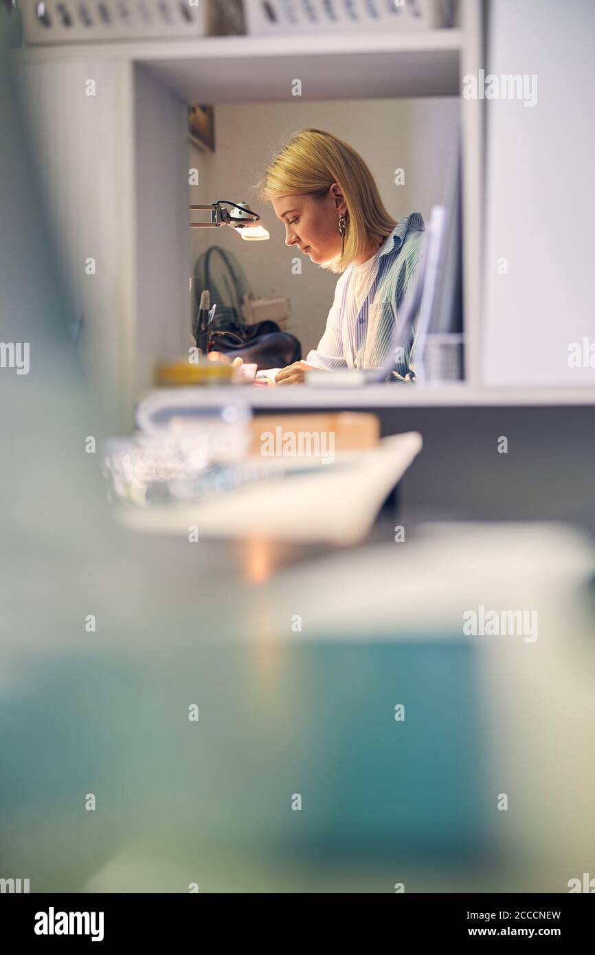 Focused employee diligently working in office room Stock Photo - Alamy