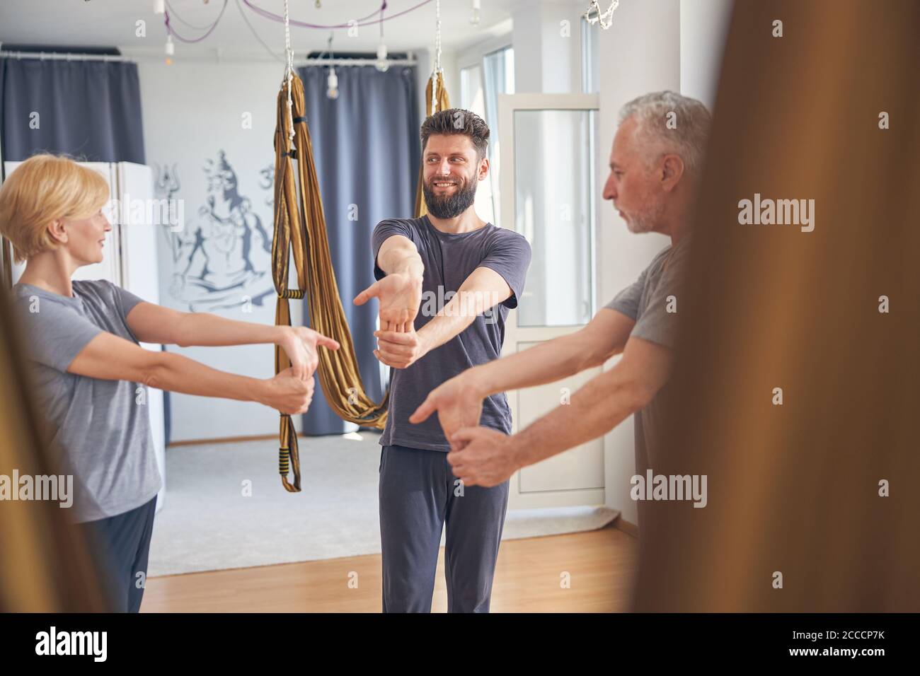 Happy coach working out with his clients Stock Photo - Alamy