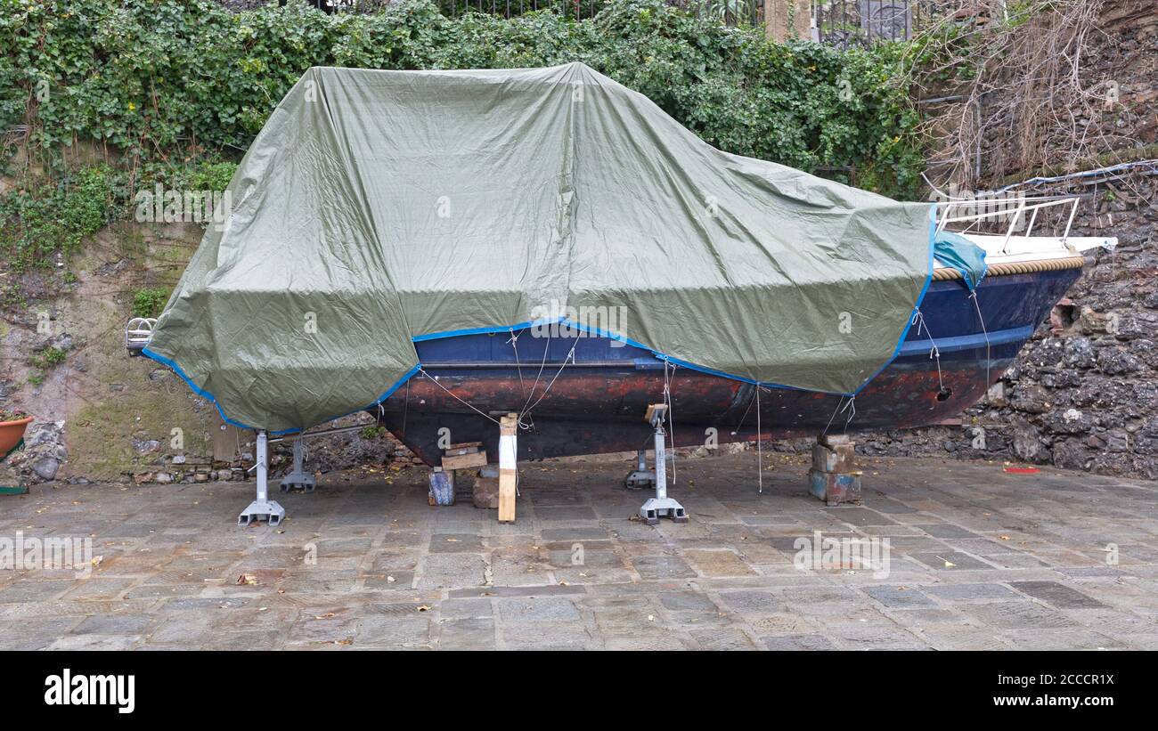 Boat Covered With Tarp Packed For Winter Protection Stock Photo - Alamy