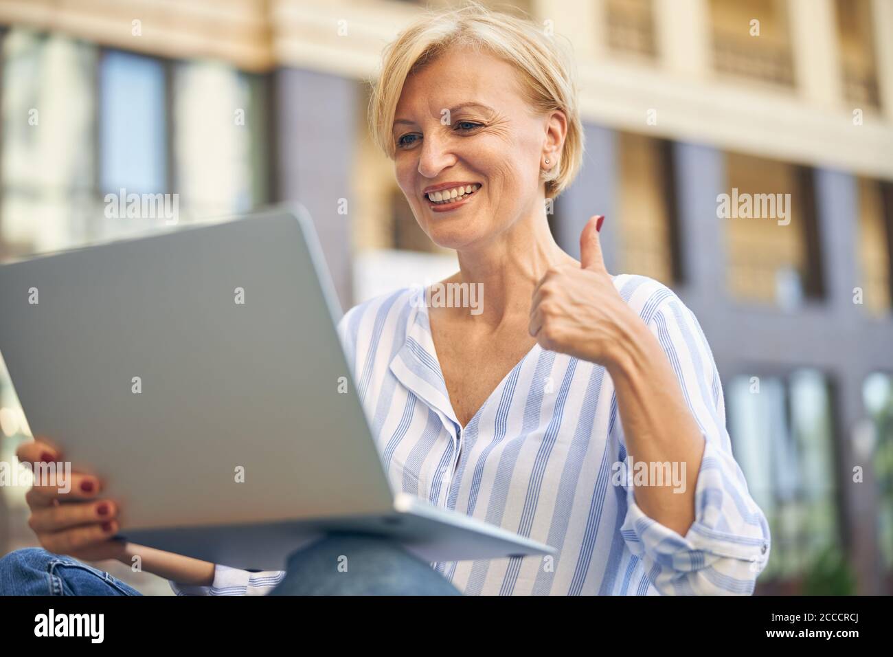 High-spirited Caucasian woman showing a gesture of approval Stock Photo ...