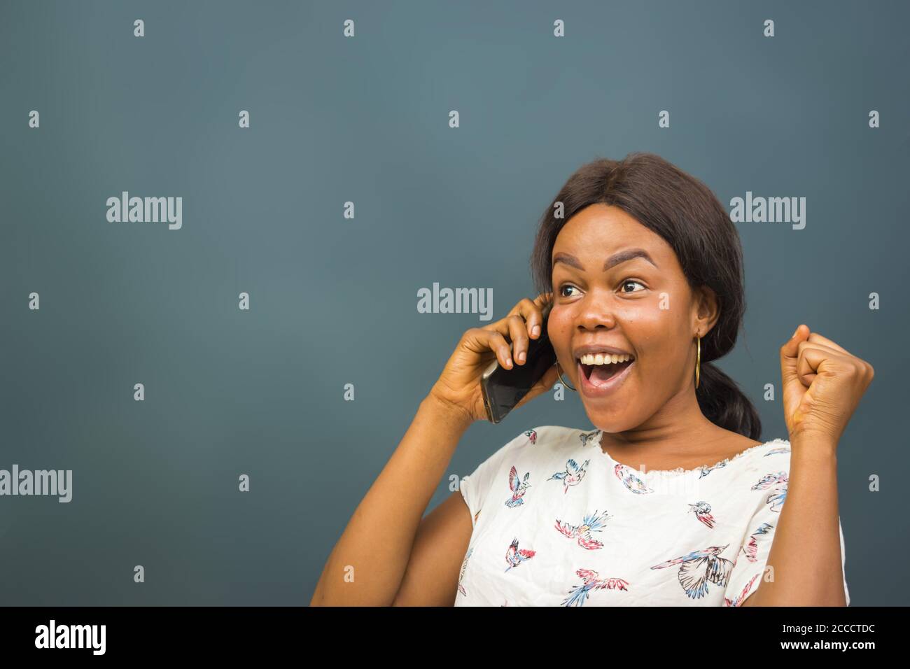 Black woman with strong expression of happiness celebrating success ...
