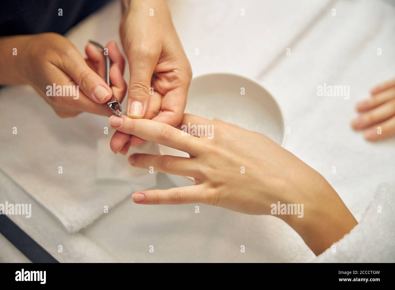 Nail artist using nipper for clients at work Stock Photo - Alamy
