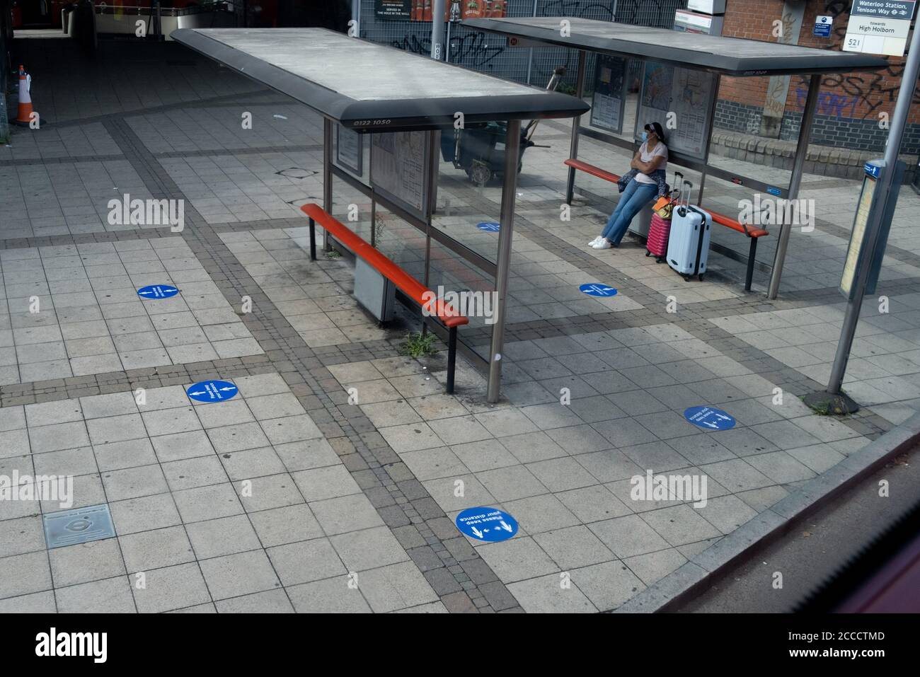 A lady bus passenger waits the next service at the bus terminal at ...