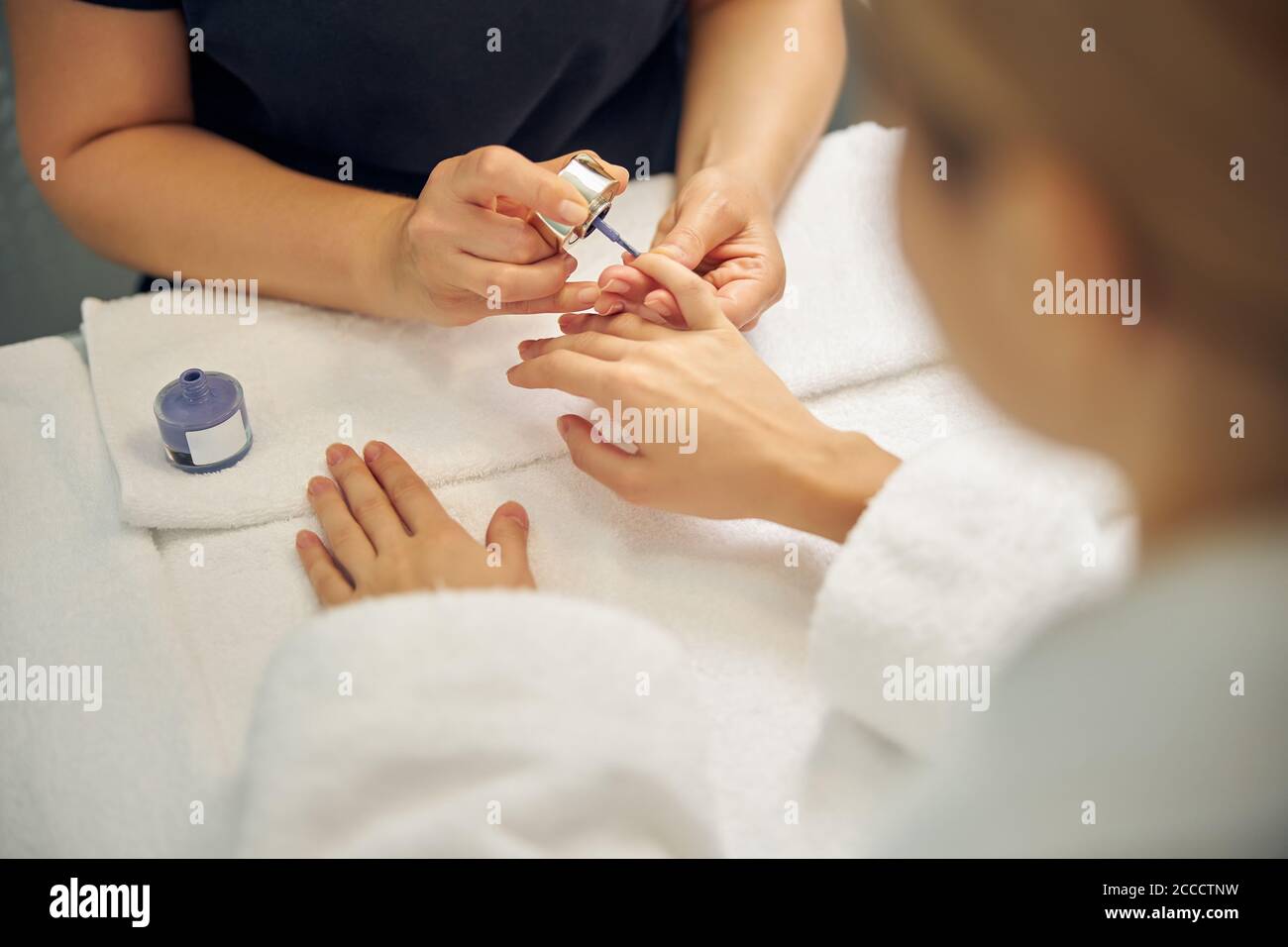 Woman having nails painted in beauty salon Stock Photo - Alamy
