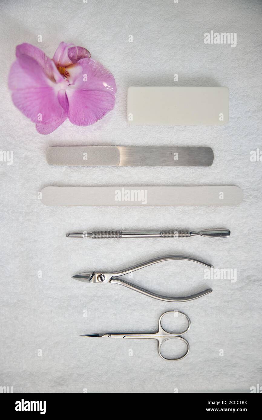 Hand instruments for fingers care with orchid Stock Photo - Alamy