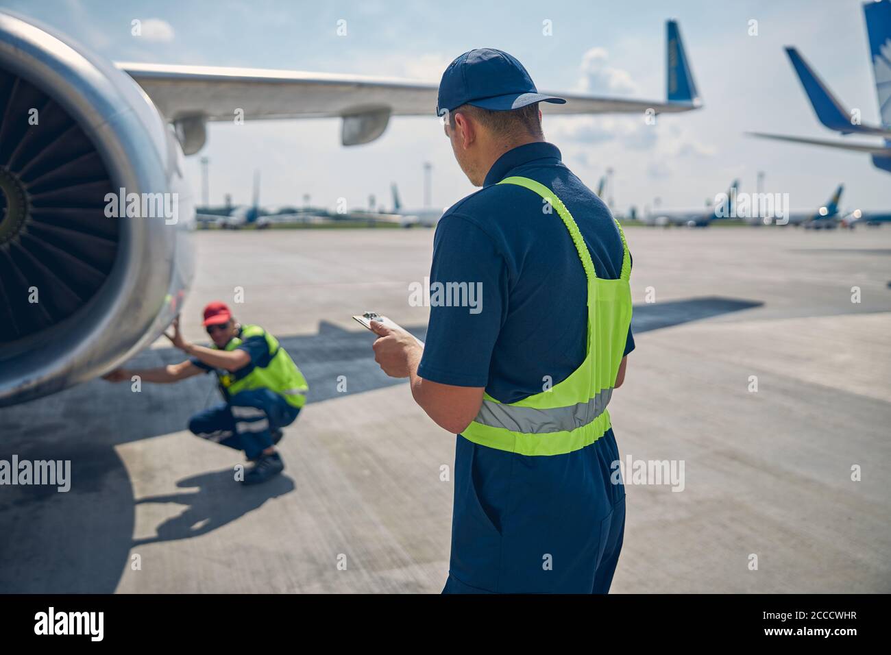 Aircraft maintenance mechanics working at the airdrome Stock Photo - Alamy