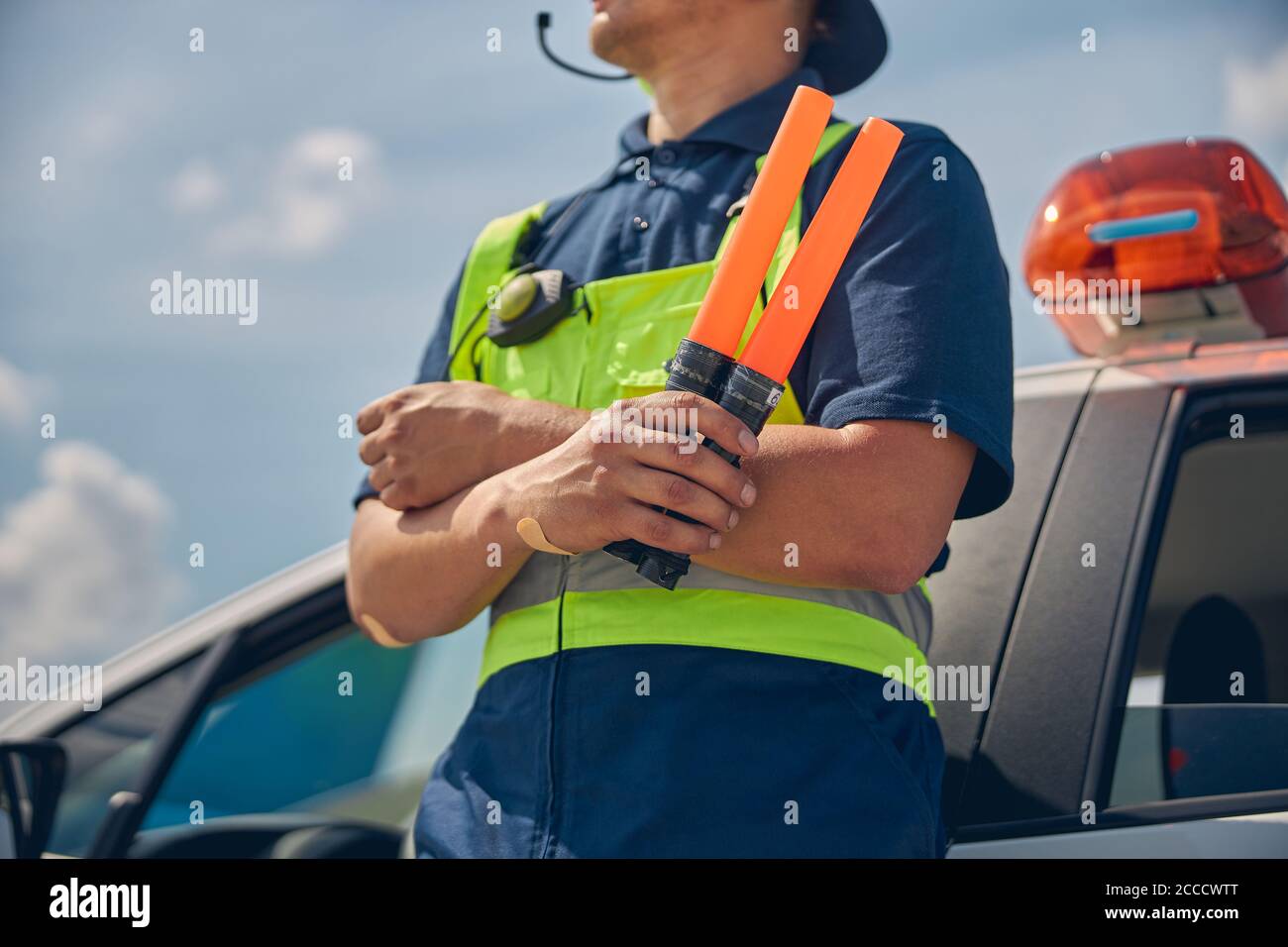 Man holding marshalling wands in one hand Stock Photo - Alamy