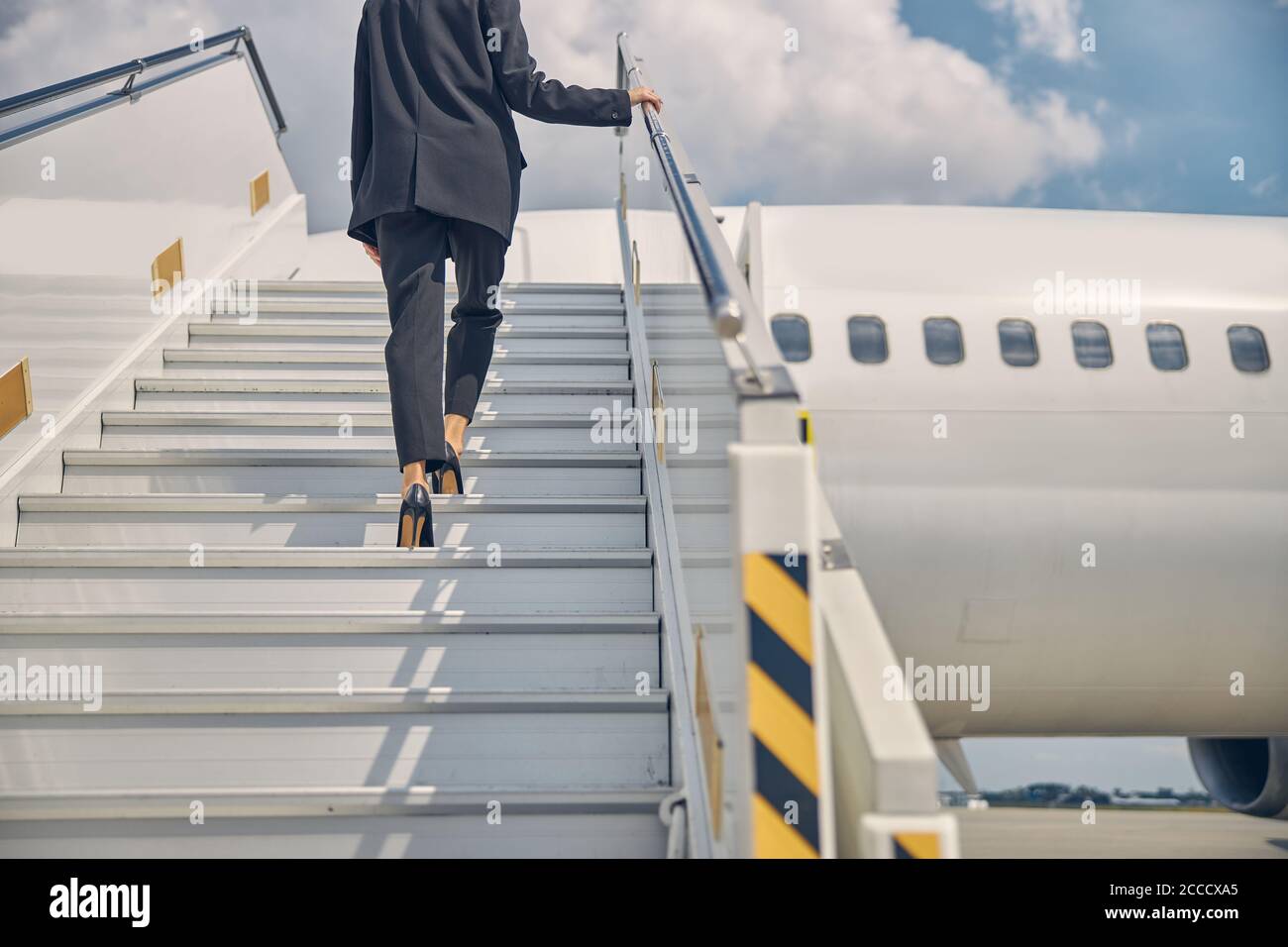 Female moving to the entrance of the aircraft Stock Photo - Alamy