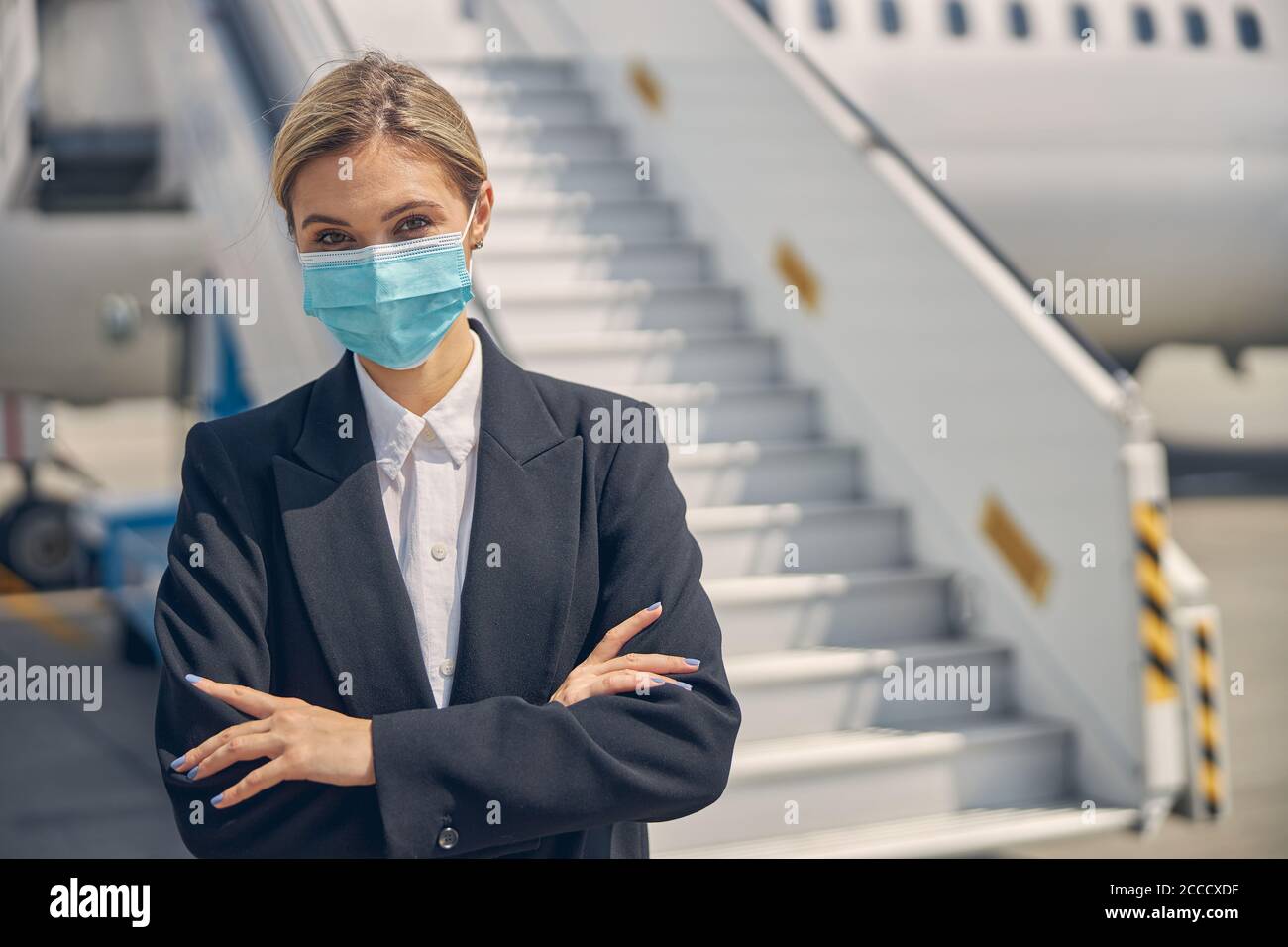 Lady in a face mask posing for the camera Stock Photo - Alamy