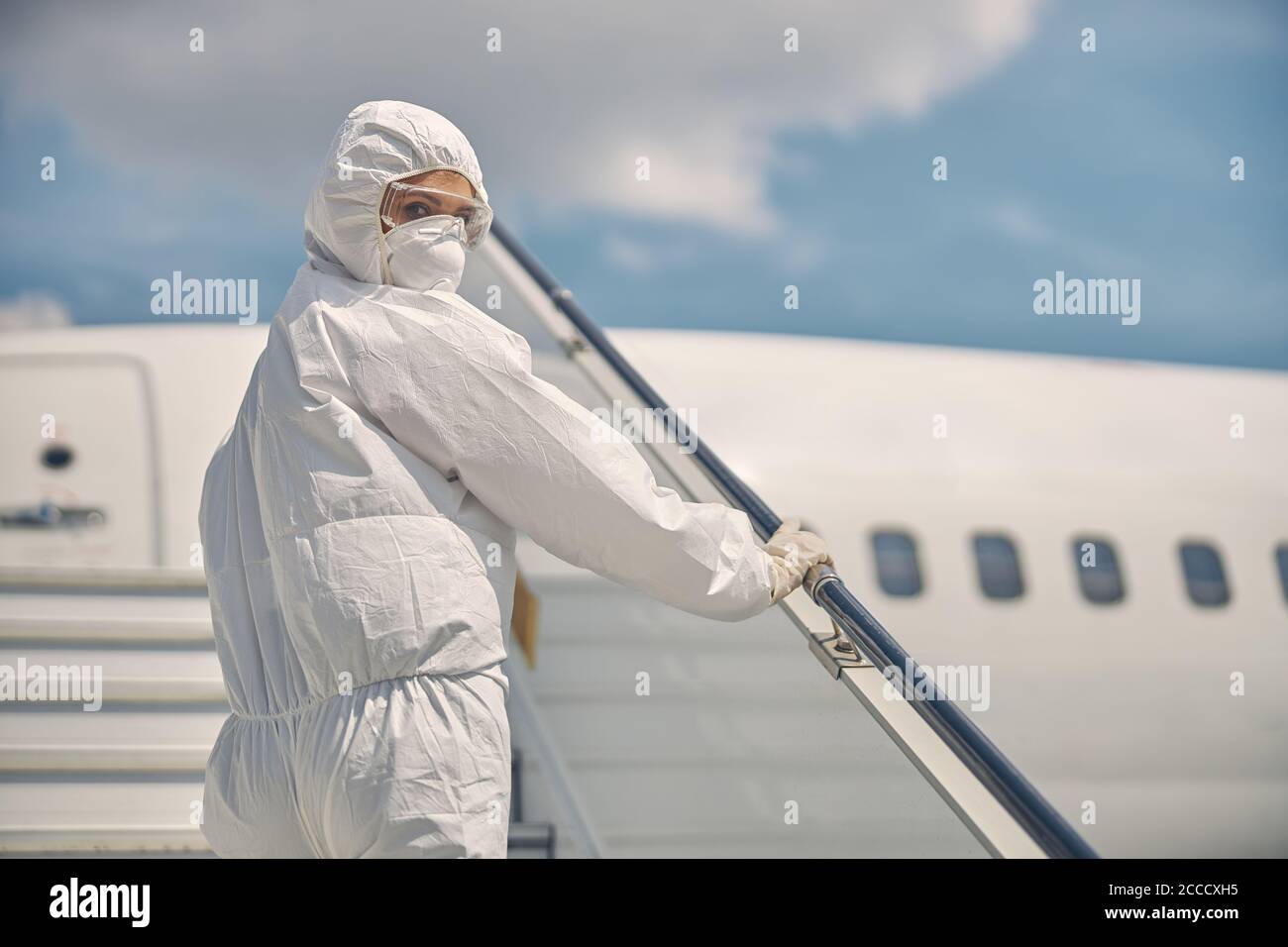Airline worker in safety goggles looking forward Stock Photo - Alamy