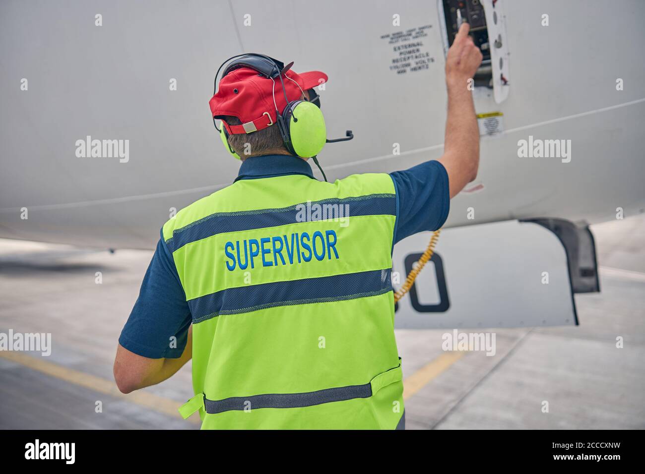 Male mechanic testing the flight interphone system Stock Photo - Alamy