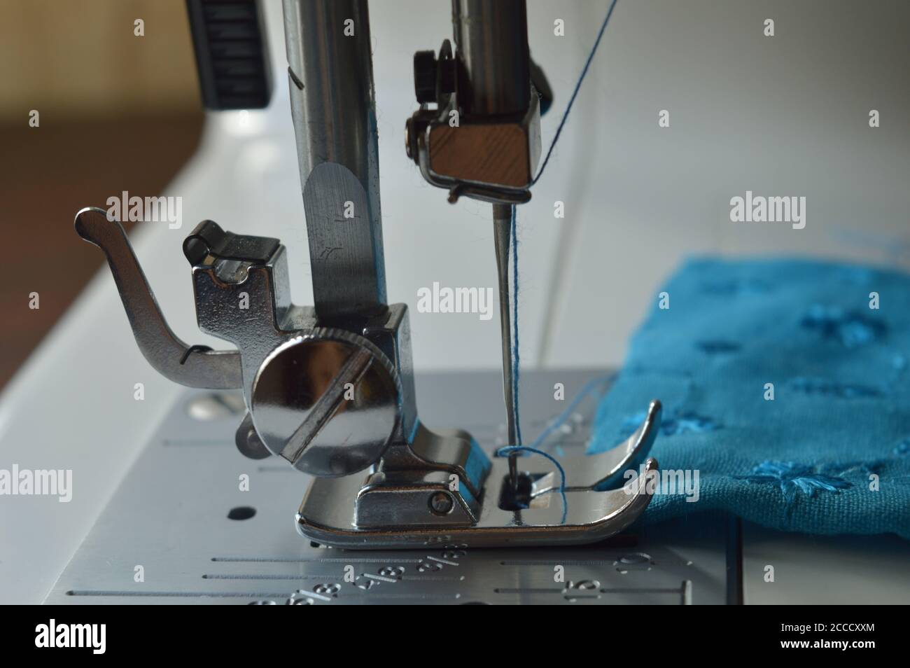 image of a sewing machine showing thread and needle. A sewing machine ...