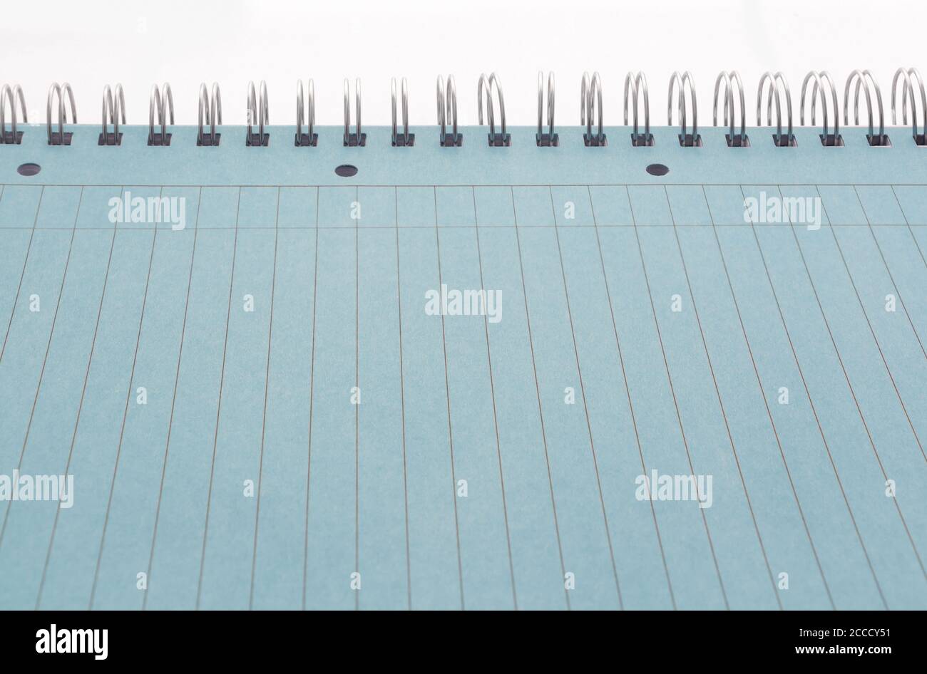 Lined page of notebook with metal rings, blue paper Stock Photo - Alamy