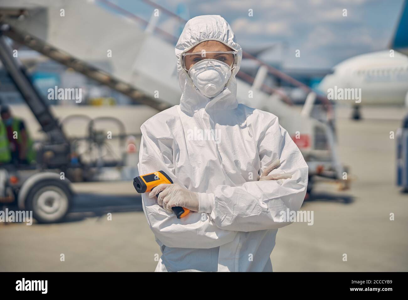 Woman with an infrared thermometer looking at the camera Stock Photo ...