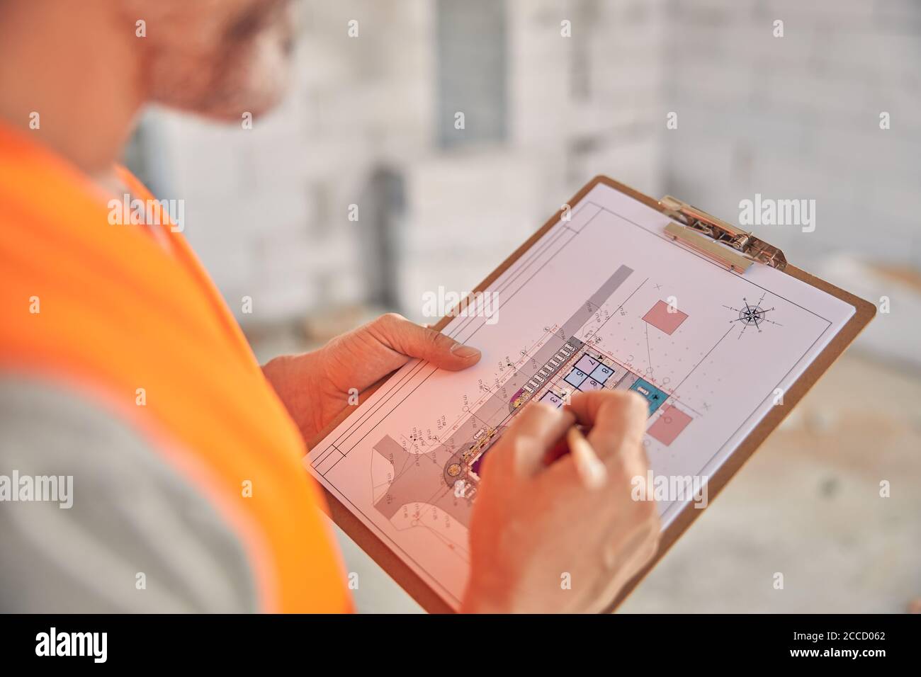Man making changes to the house plan Stock Photo - Alamy