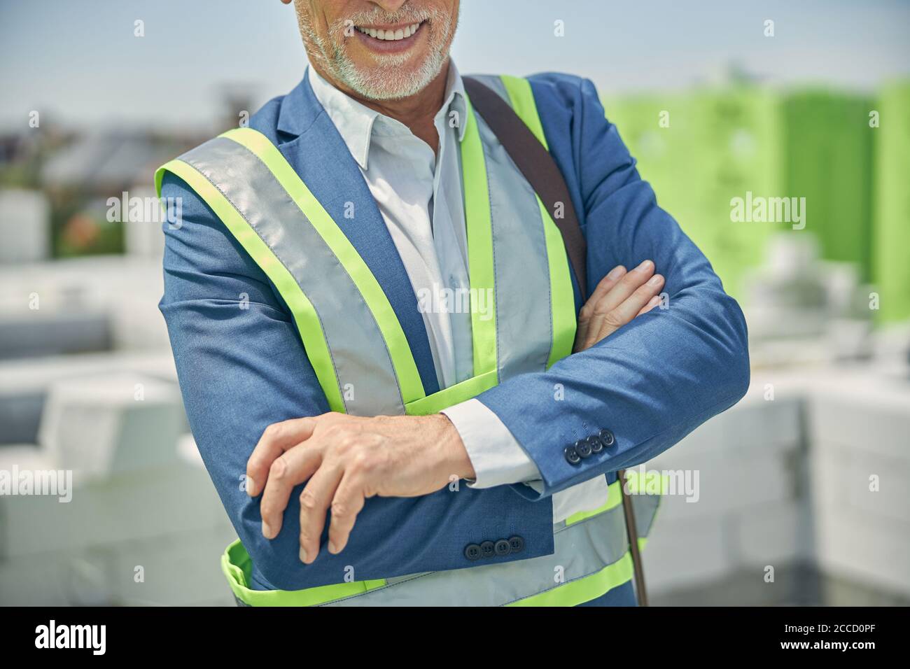 Modern civil engineer with his arms folded standing outside Stock Photo ...
