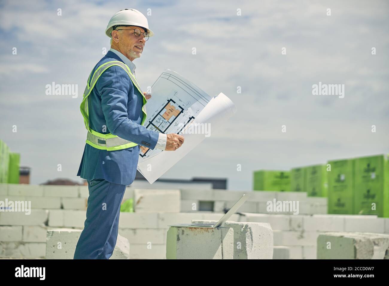 Man in a safety helmet looking away Stock Photo - Alamy