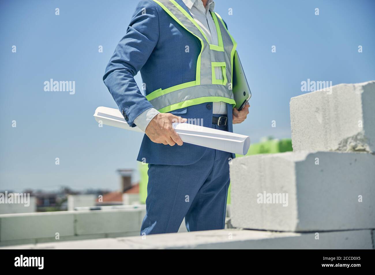 Man holding a laptop under his arm Stock Photo - Alamy