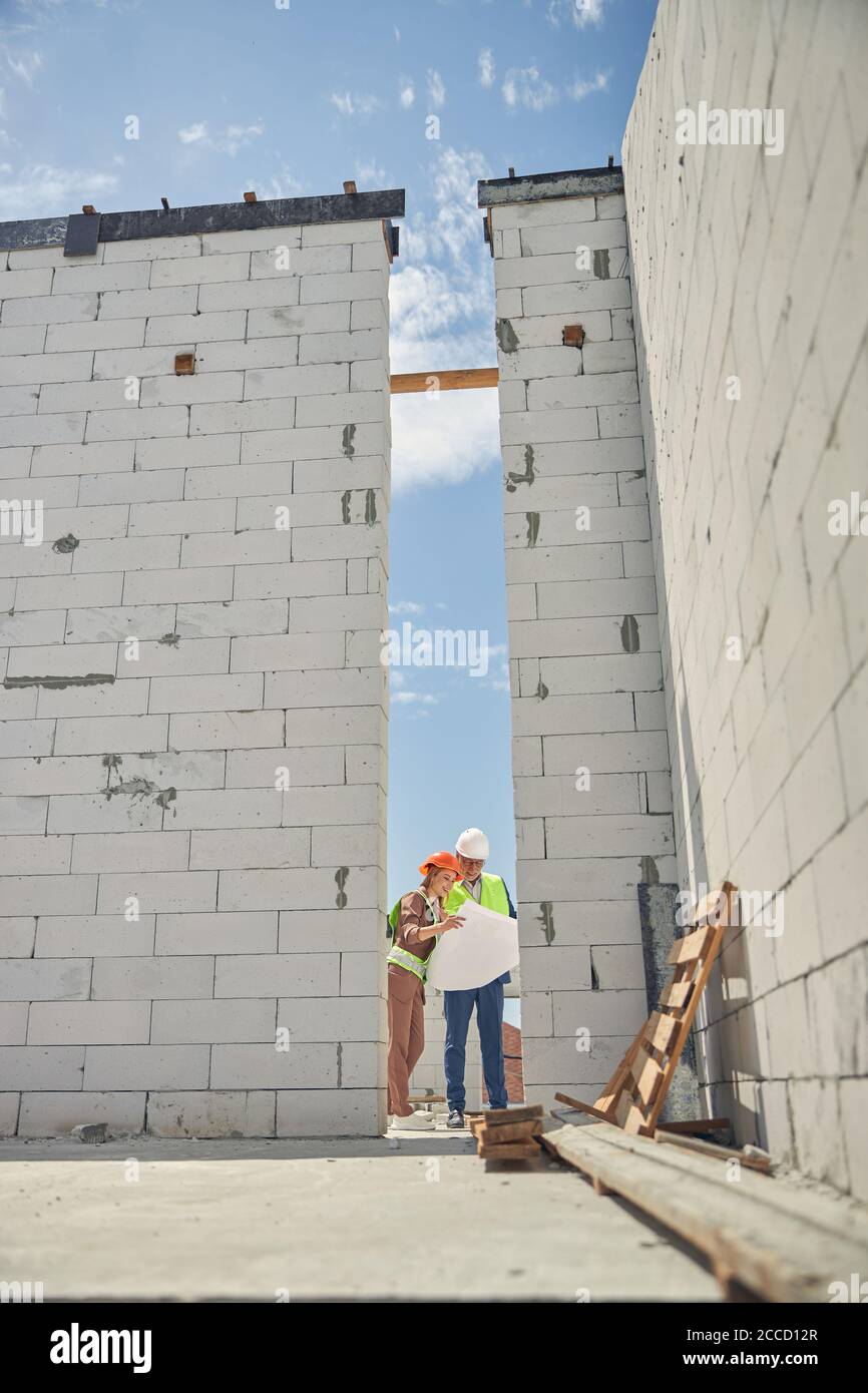 Two joyous civil engineer working together outside Stock Photo - Alamy