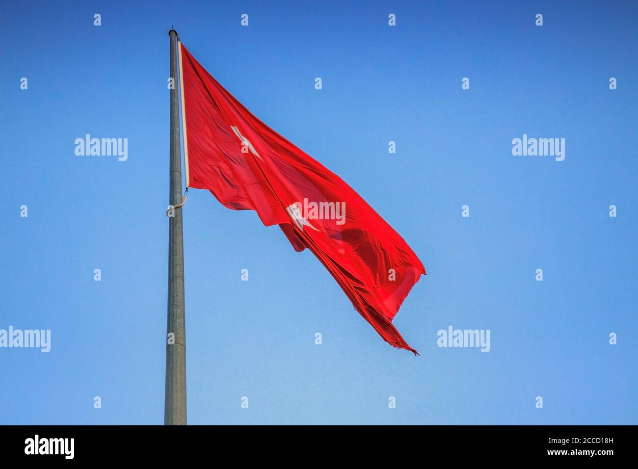The Turkish flag flutters against a clear blue sky Stock Photo - Alamy