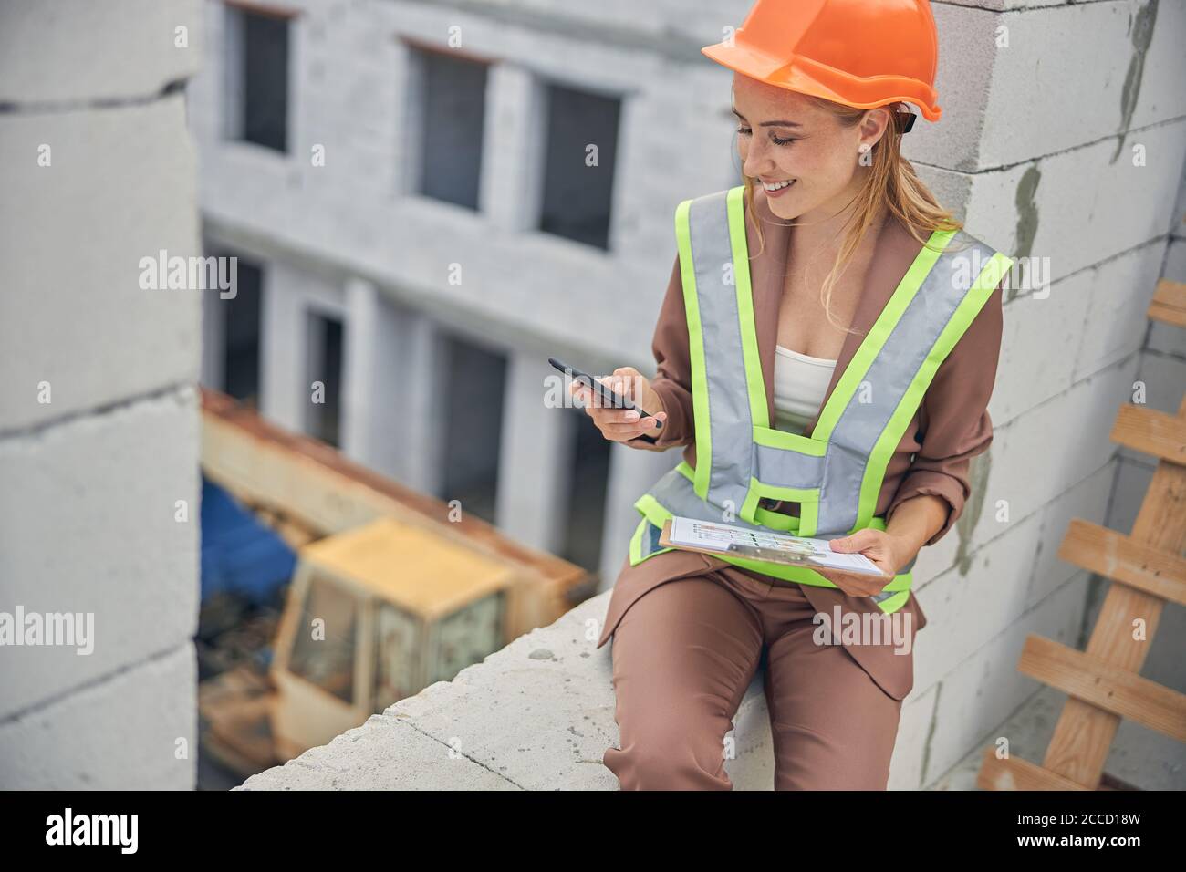Smiling lady staring at her mobile phone Stock Photo - Alamy