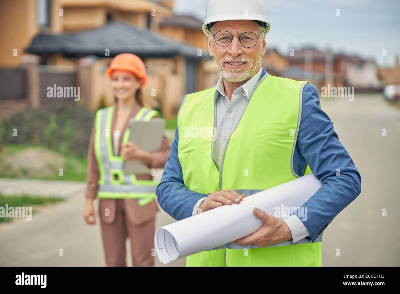 Contented senior man holding his technical drawings Stock Photo - Alamy