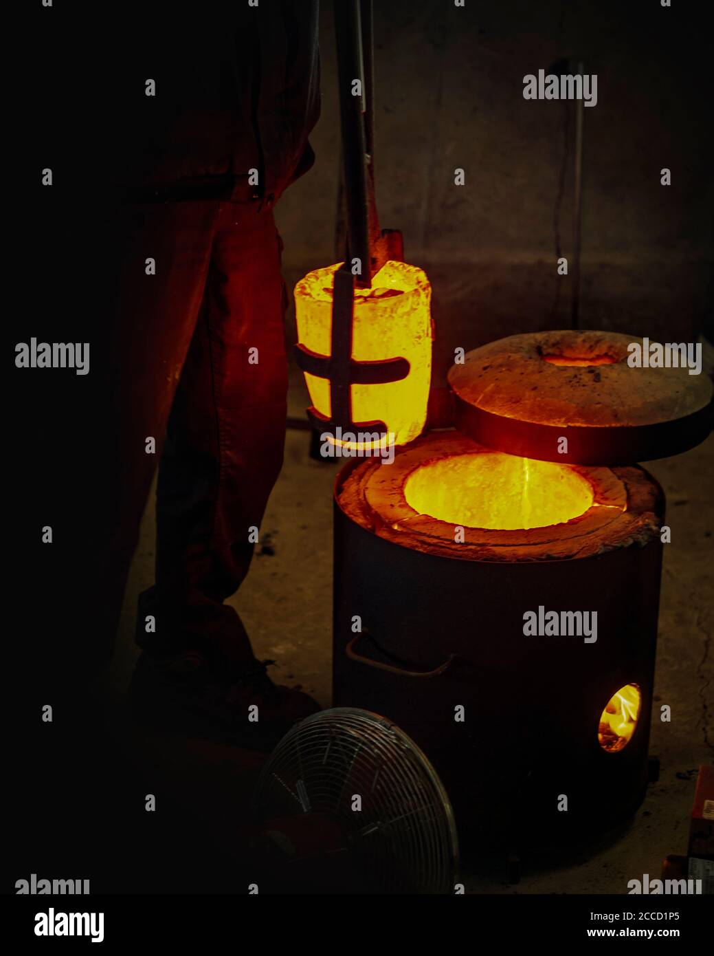 Casting the Bronze in small foundry. Sequence of images shows ...