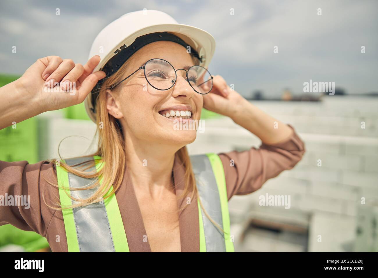 Attractive young blonde construction worker looking up Stock Photo - Alamy