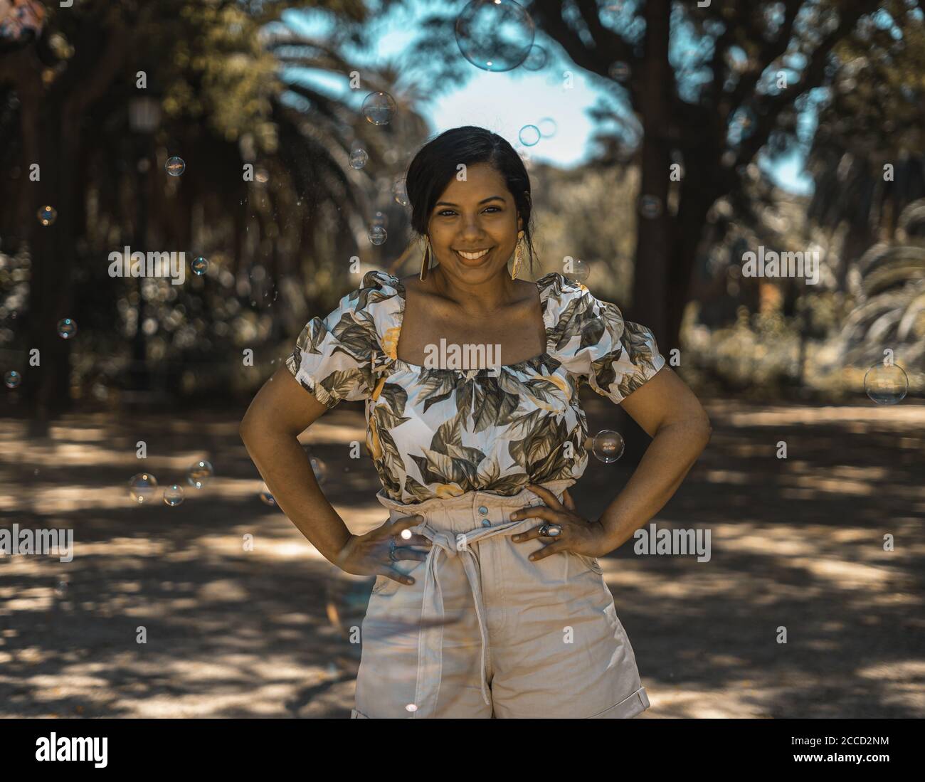 Closeup portrait of a young smiling Hispanic female posing at the ...