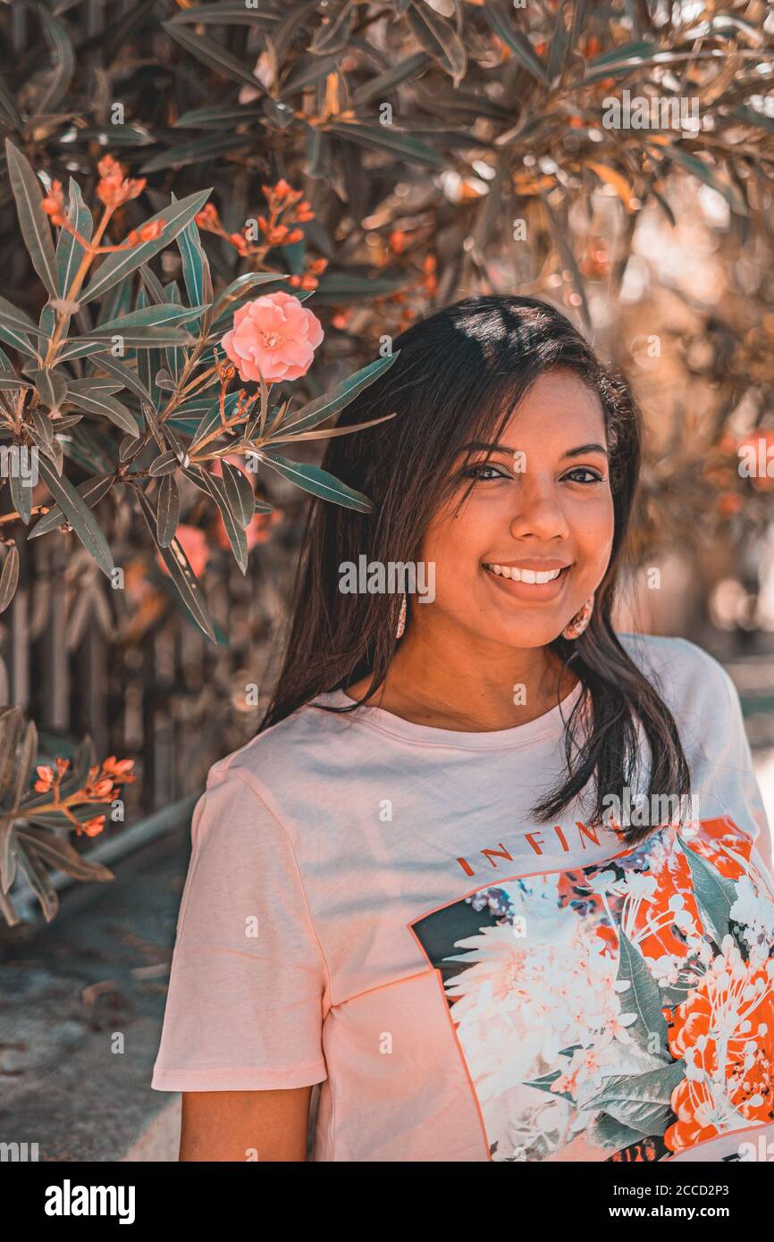 Closeup portrait of a young smiling Hispanic female posing at the ...