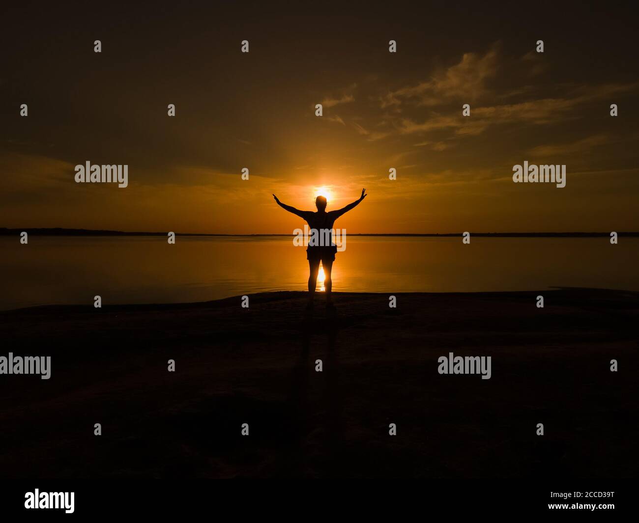 Dark orange sunset on the sea beach Stock Photo - Alamy