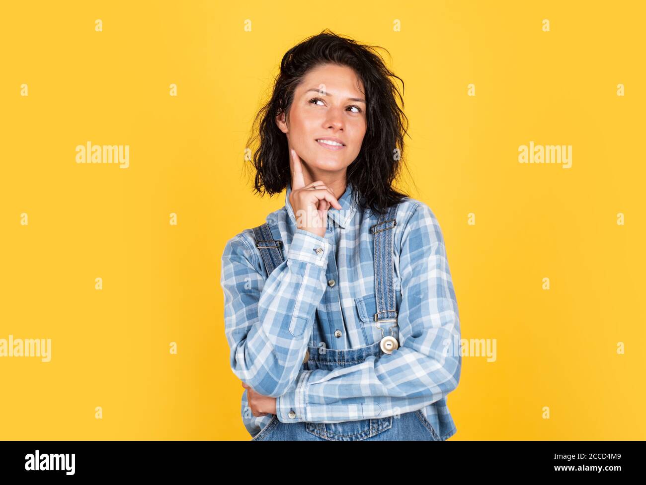let me think. girl on yellow background. joyful and charming smile ...