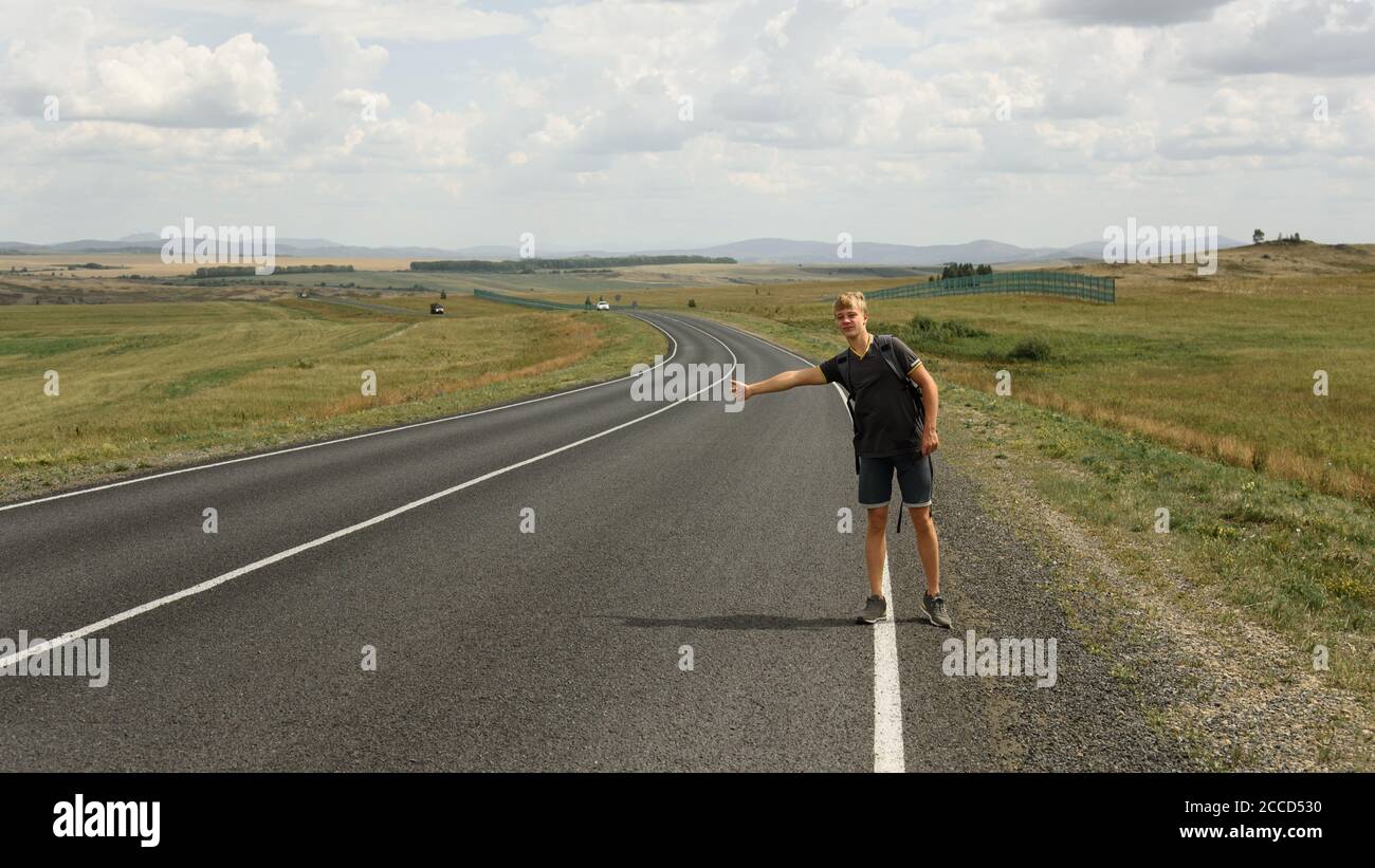 A young man catches a car Stock Photo - Alamy