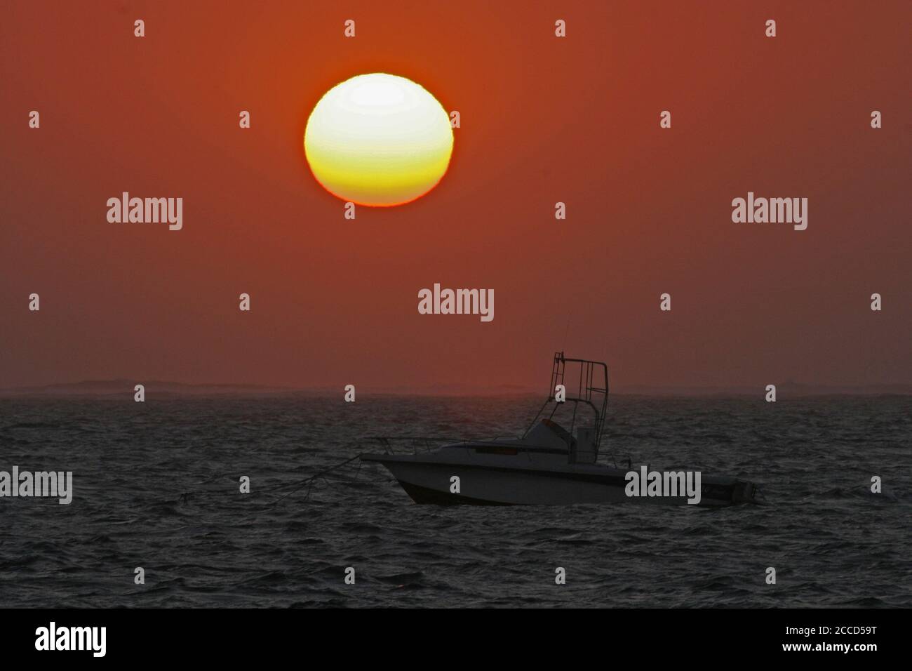 Sunset over the Indian ocean at Ifaty in Madagascar. A motor boat ...