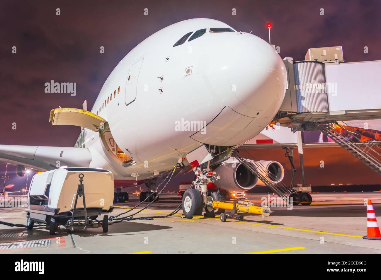 Night view of nose and cockpit a large plane during pre-flight ...
