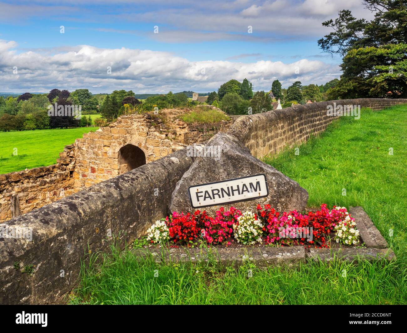 Roadside village sign with summer flowers entering the village of ...