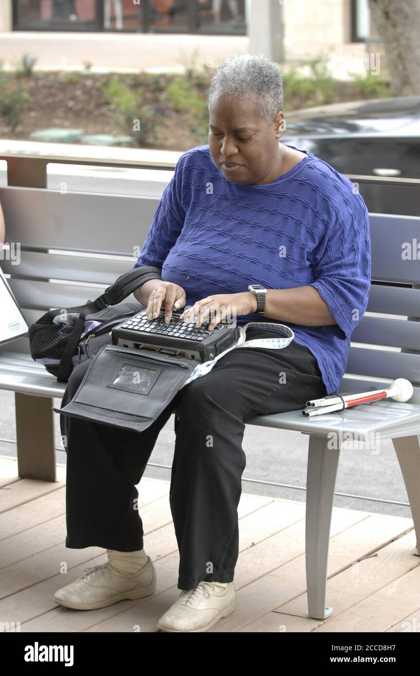 Austin, TX USA, April 23, 2007: An African-American shopper types on ...