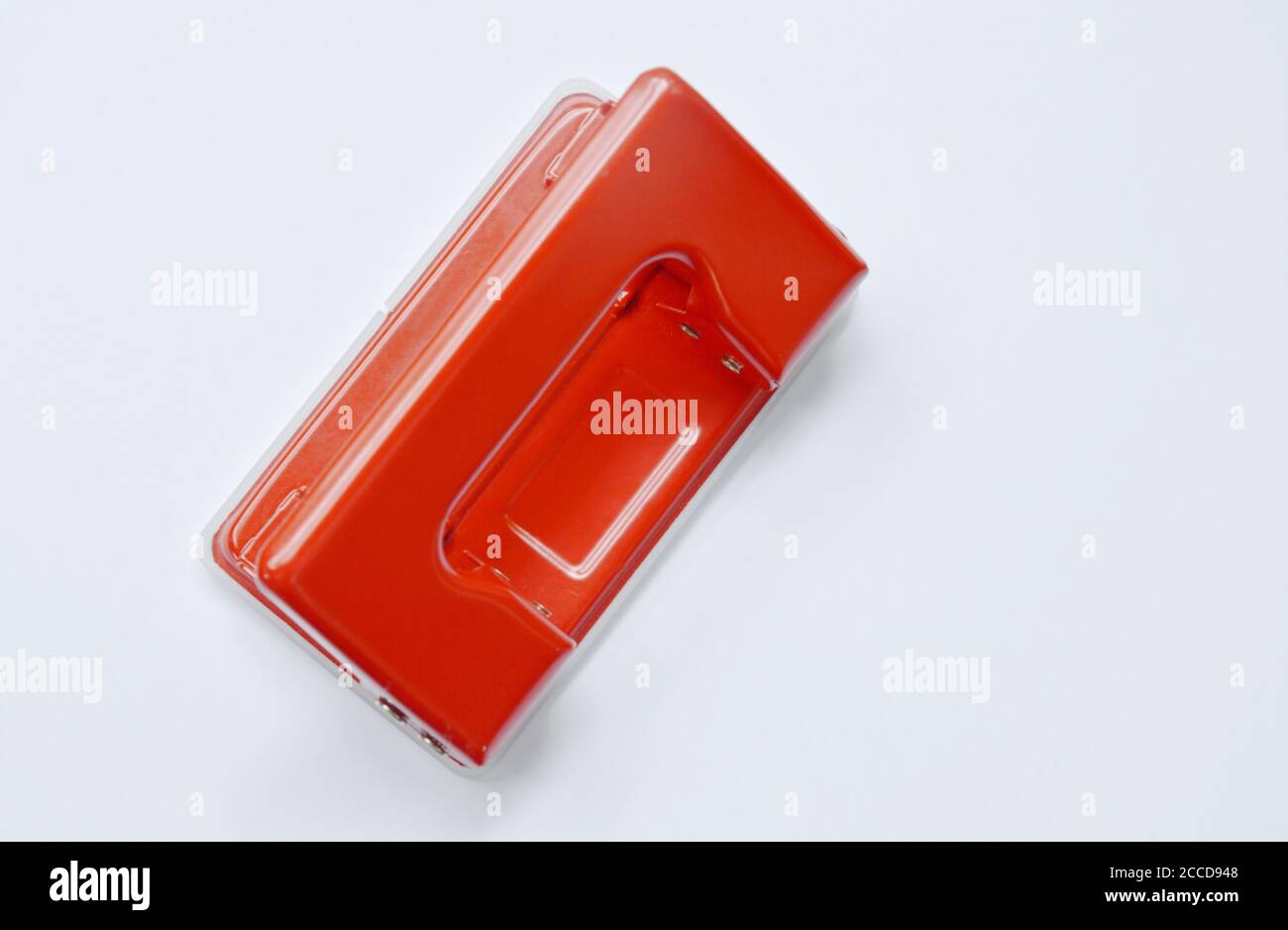 Red punch pushing paper on white background Stock Photo - Alamy