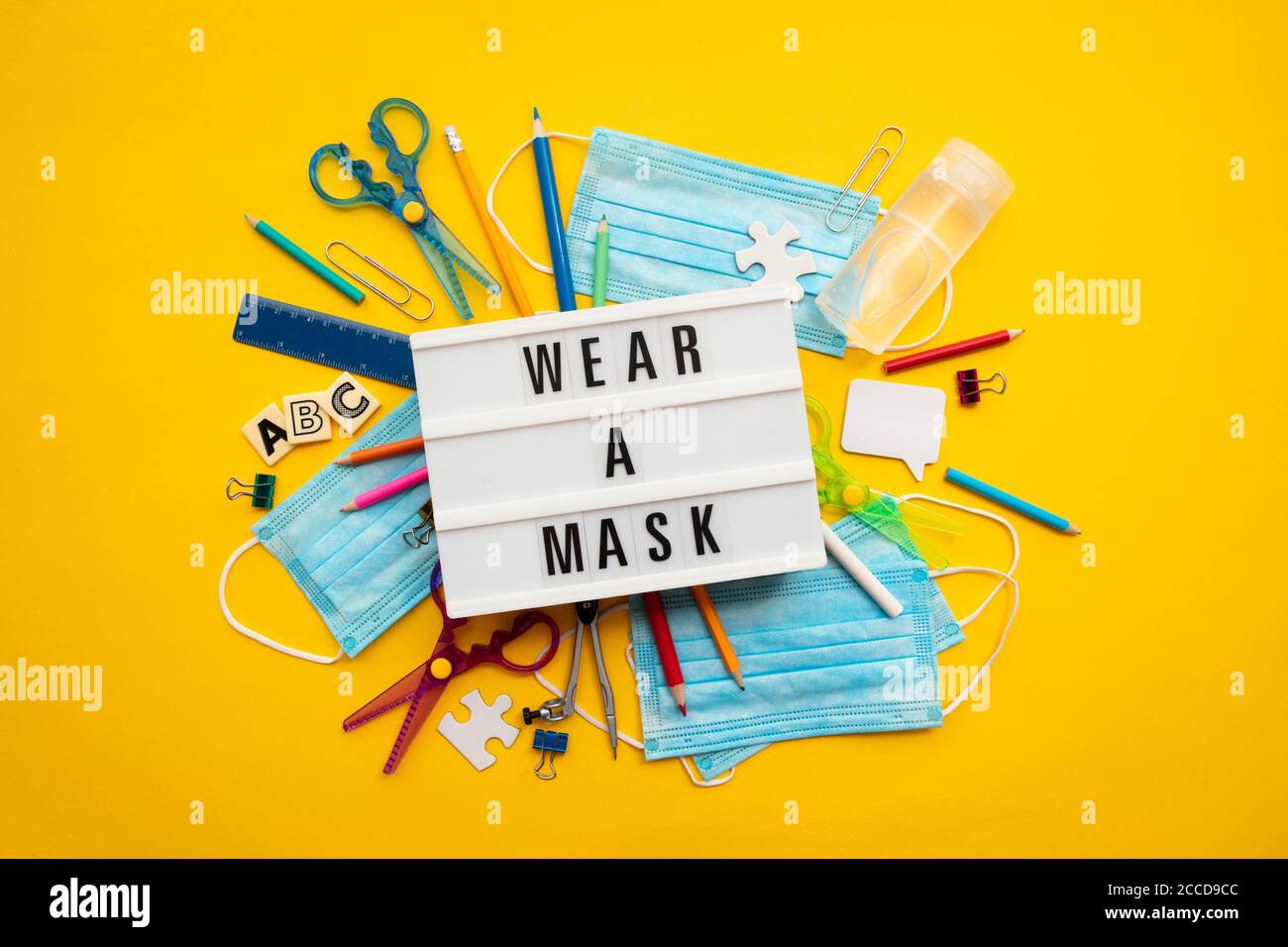 Wear a mask lightbox message with school equipment and covid masks ...