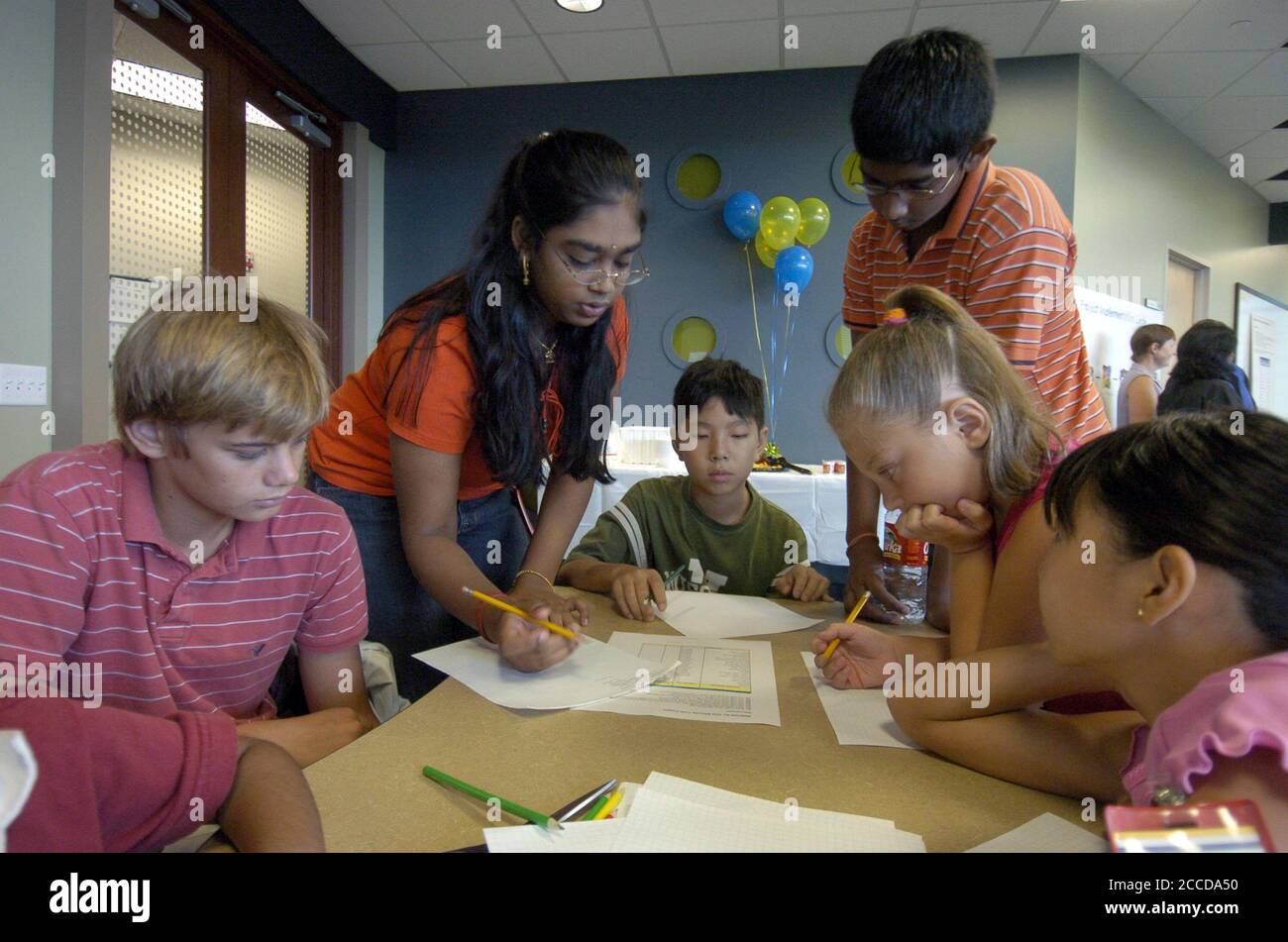 Children work on an egg-drop project at a "Take-your-child-to-work day ...