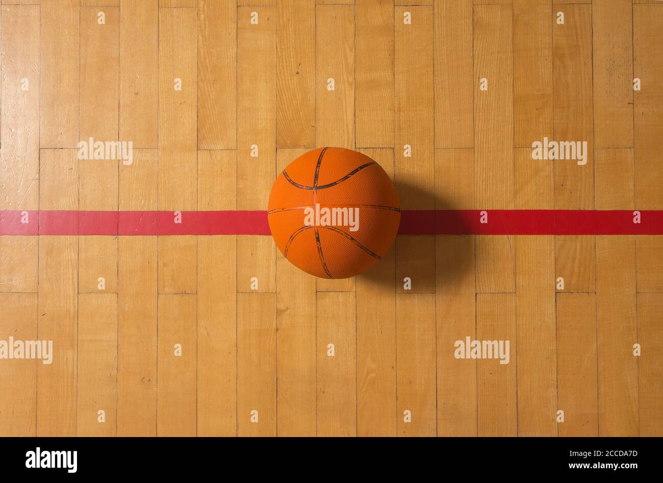Basketball ball on a basketball court, with red line Stock Photo - Alamy