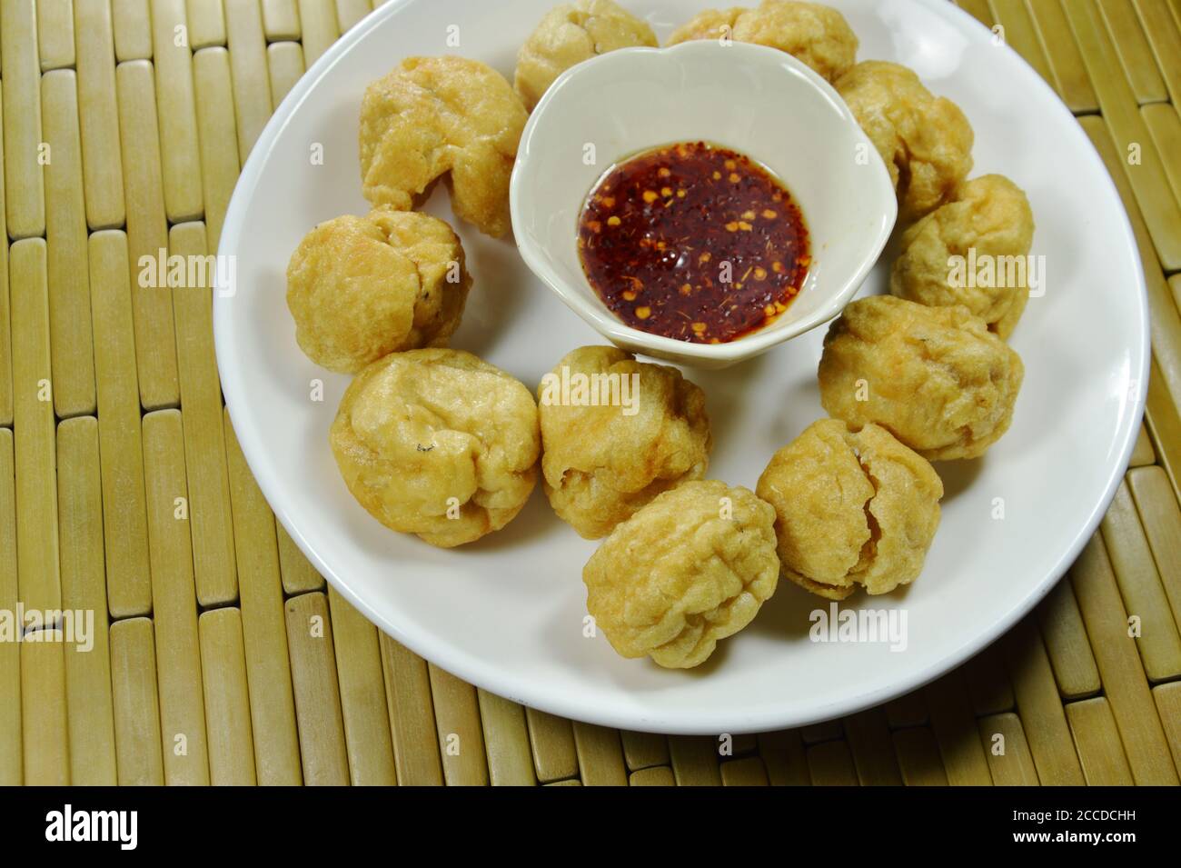 crispy fried fish ball stabbing in wooden stick dipping spicy and sweet ...