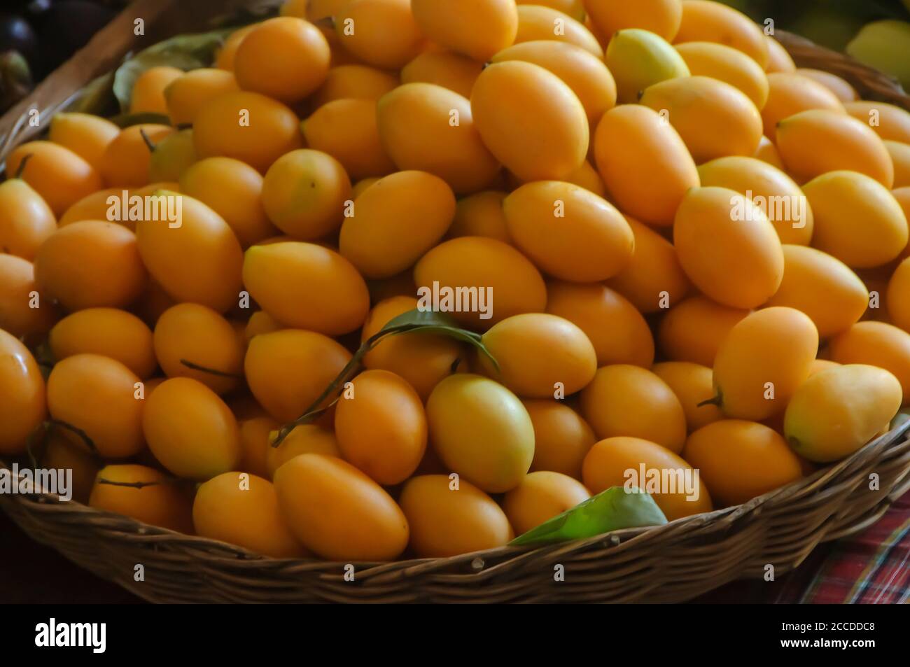 Plum Mango tropical fruit on bamboo tray in the market, ripe of sweet ...