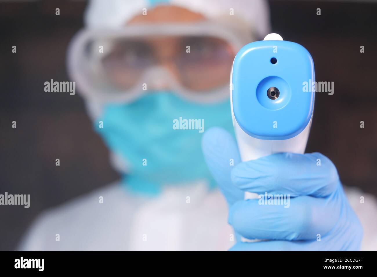 Hand holding infrared thermometer to measuring temperature Stock Photo ...