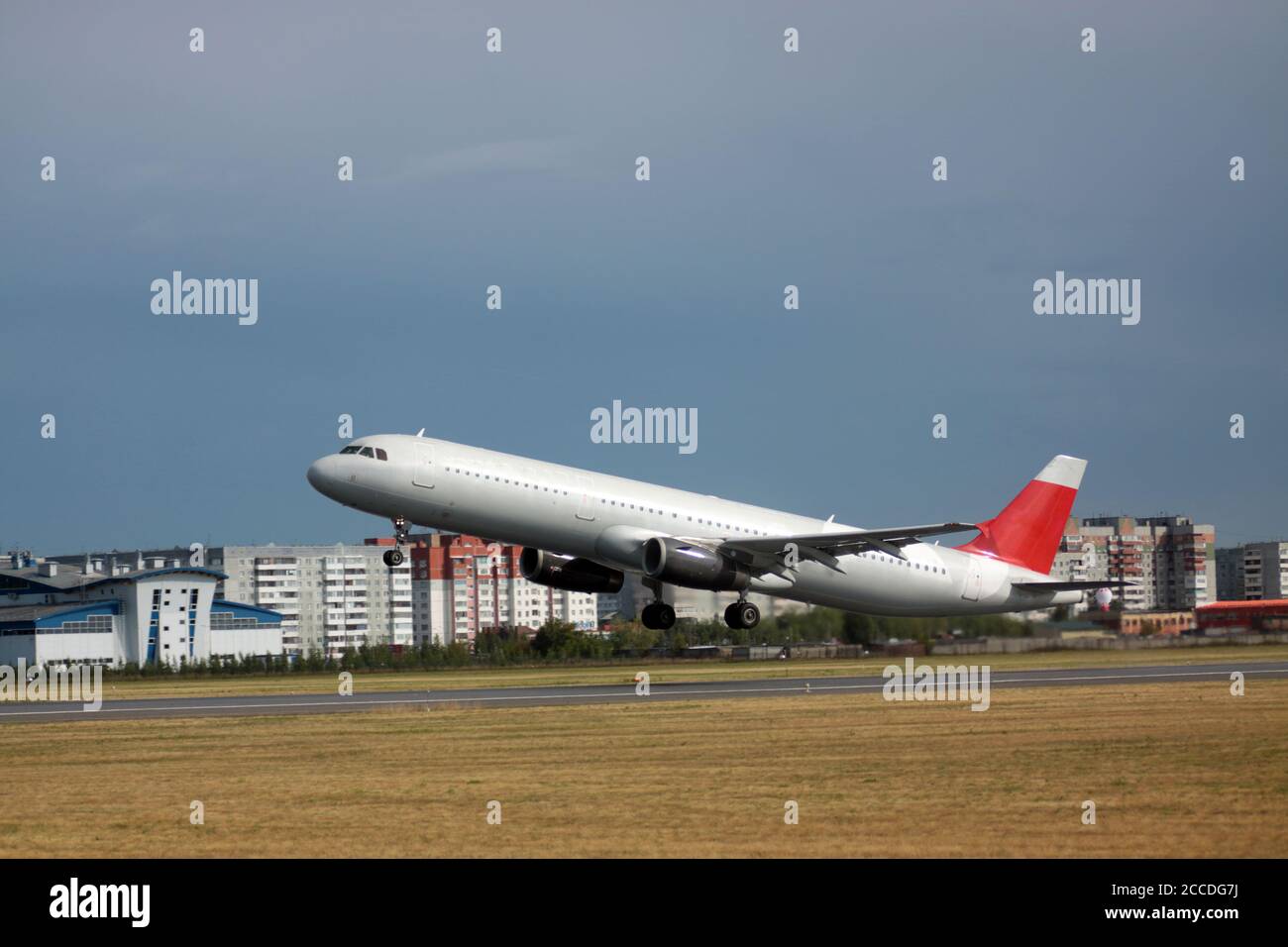 Passenger plane takes off from the airport runway. Side-view of ...