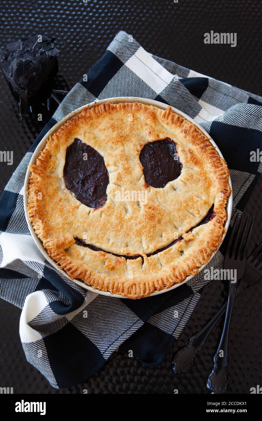 Homemade cherry pie with a scary face for Halloween Stock Photo - Alamy