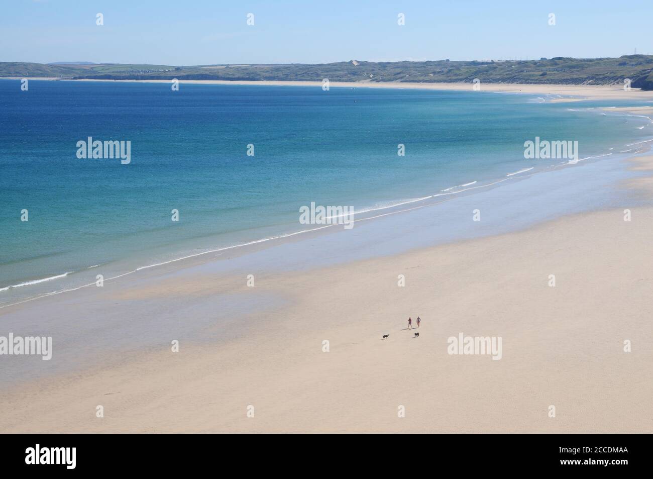 Early morning dog walkers on Porth Kidney Sands, between Carbis Bay and ...